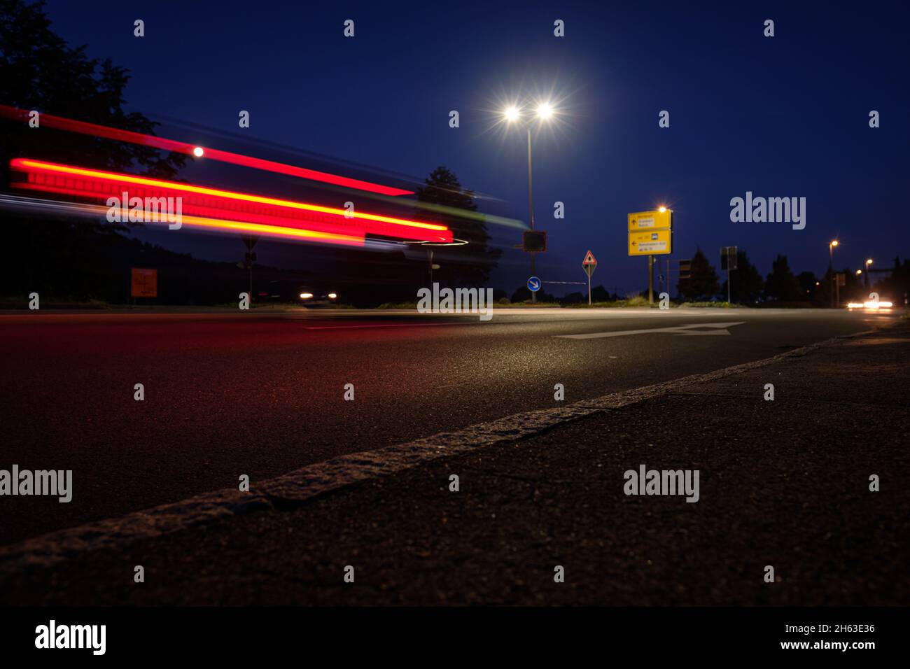 Abstract Red car light on a road crossing Stock Photo - Alamy