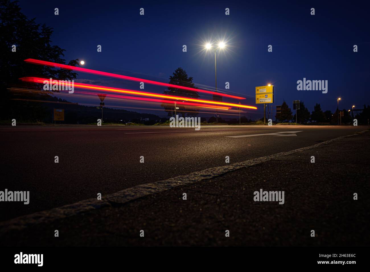 Red car brake abstract light trails at a crossing road Stock Photo - Alamy