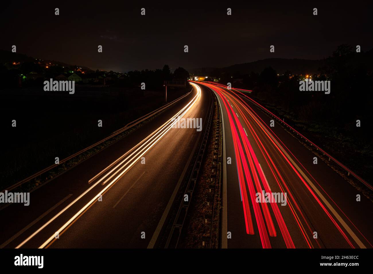 Abstract red car light trails on a road glowing Stock Photo - Alamy