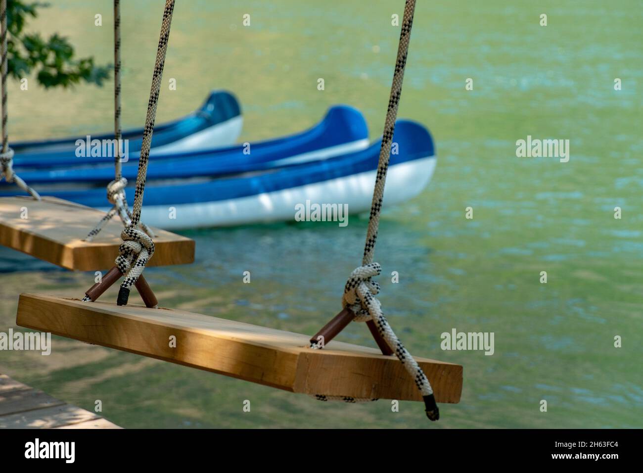 Swing and Canoe with Green Trees and Blue Lake in Turkey Stock Photo ...