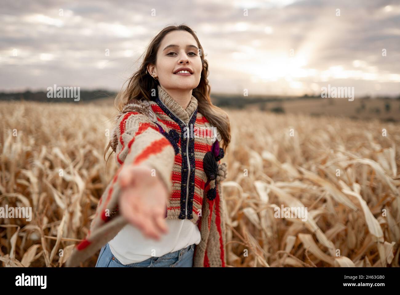 Latin woman reaching out to camera, inviting to a trip. Come with me ...
