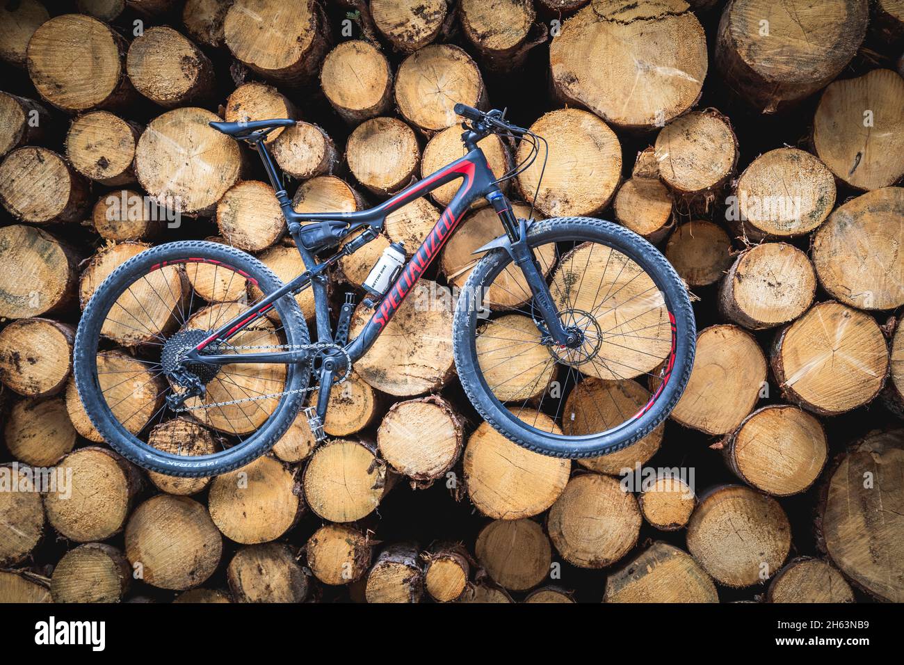 mountain bike,side view,hanging from a pile of logs Stock Photo - Alamy