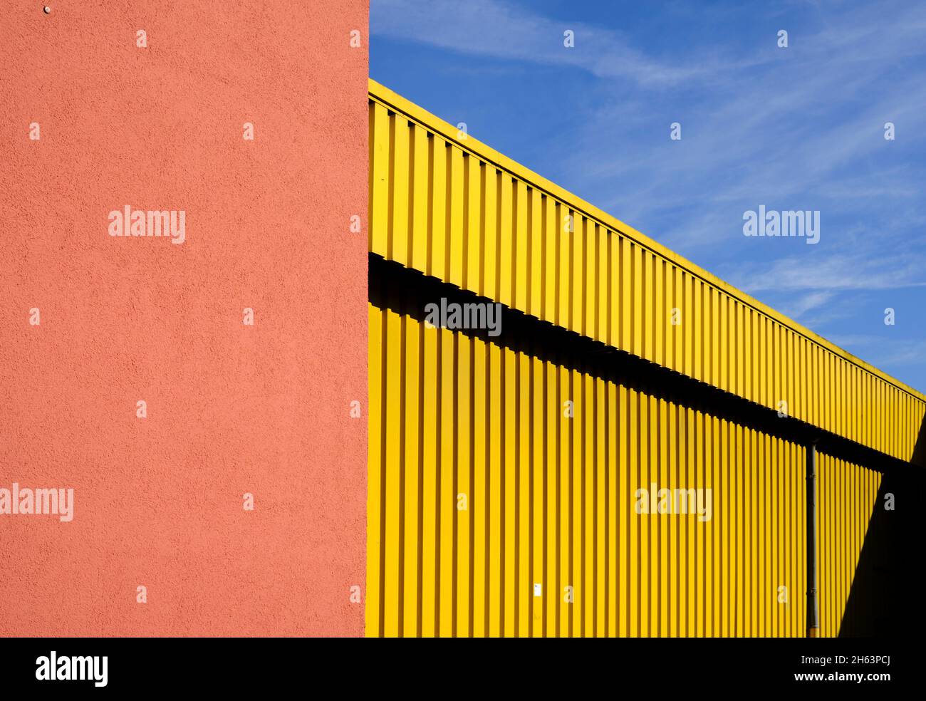 warehouse with red and yellow wall Stock Photo - Alamy