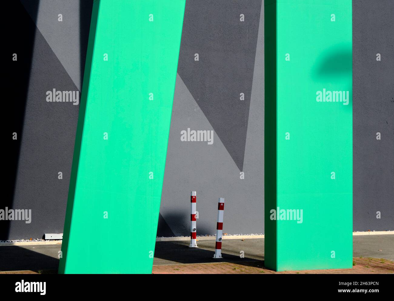 two bollards,green pillars,shadow play Stock Photo - Alamy