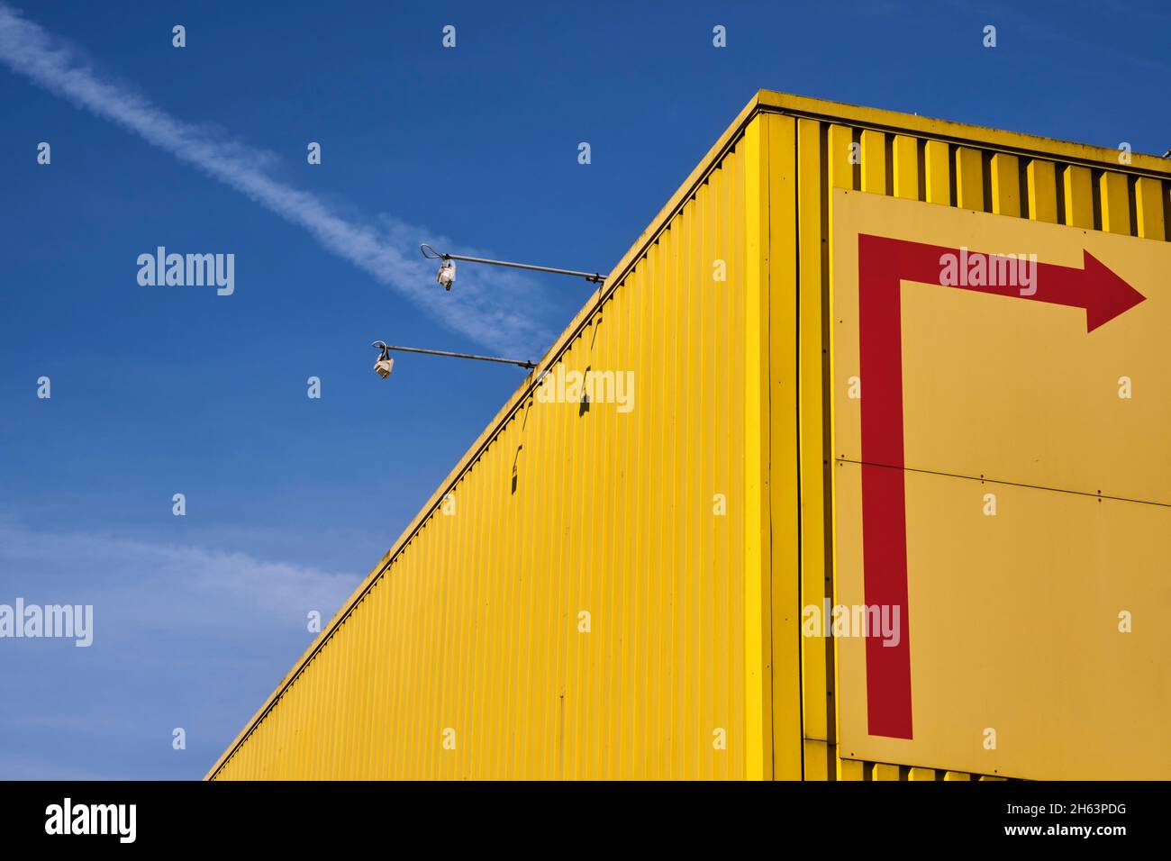 red arrow,yellow warehouse,blue sky,industrial park Stock Photo - Alamy