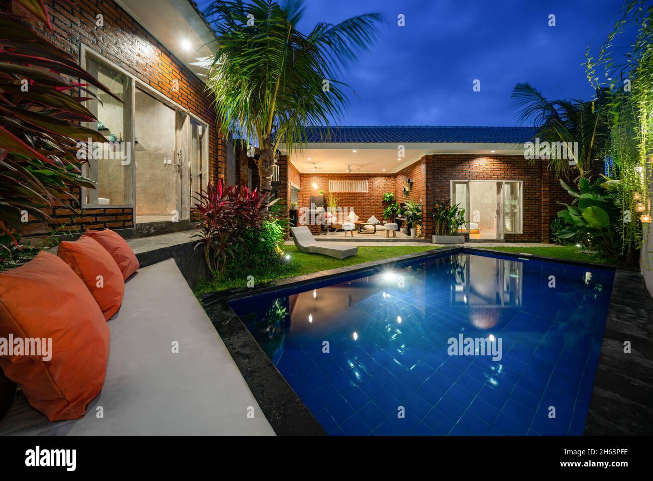 Pool in the tropical garden by night Stock Photo - Alamy