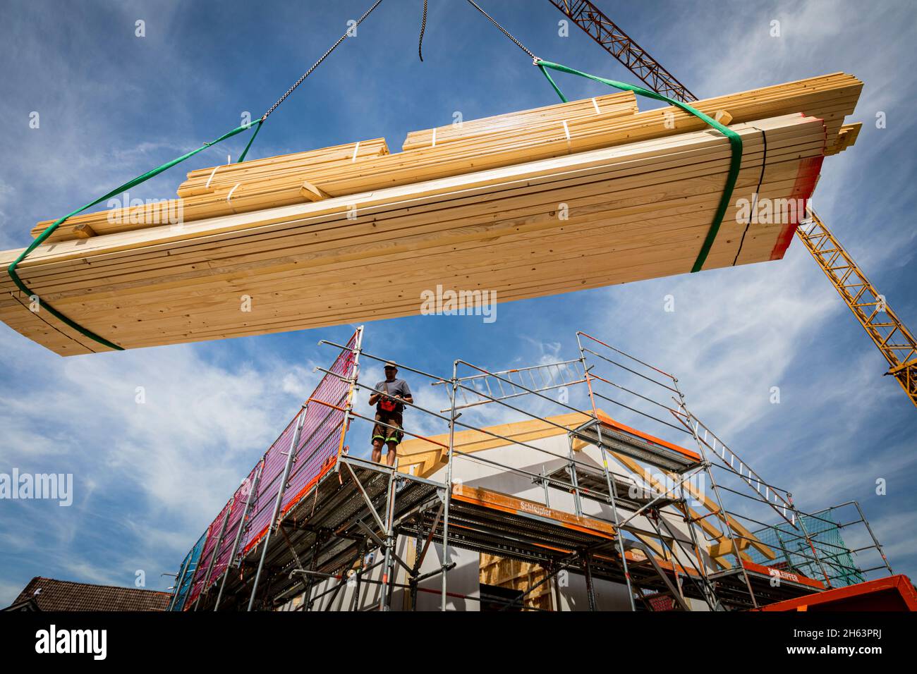 Transport of wooden beams with construction crane hi-res stock ...