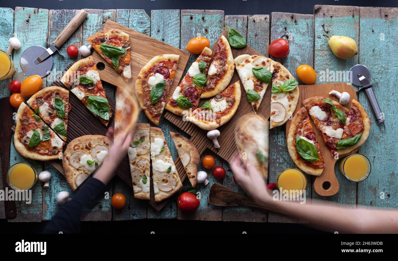 Homemade pizzas with chidrens hands motion blur overhead view Stock ...