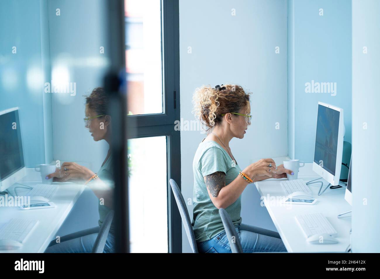 modern adult woman work at home or office desktop computer - young ...