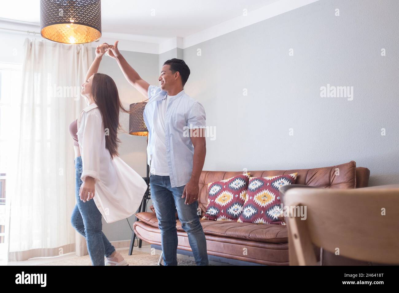 happy mixed race ethnicity husband and wife feel excited dancing ...