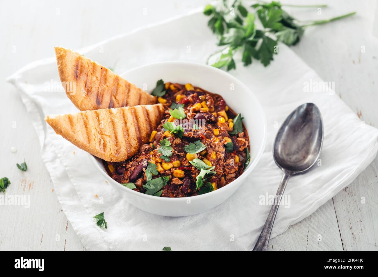 vegetarian chili prepared with soy,with grilled bread in a bowl ...