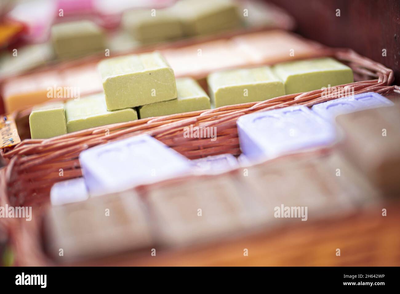 stack of soap bars in abundance inside wicker basket. fresh scented ...
