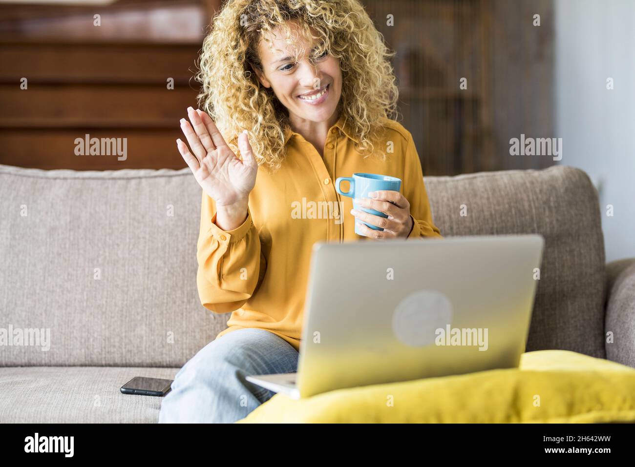 happy adult middle age cheerful woman say hello and smile doing a video ...