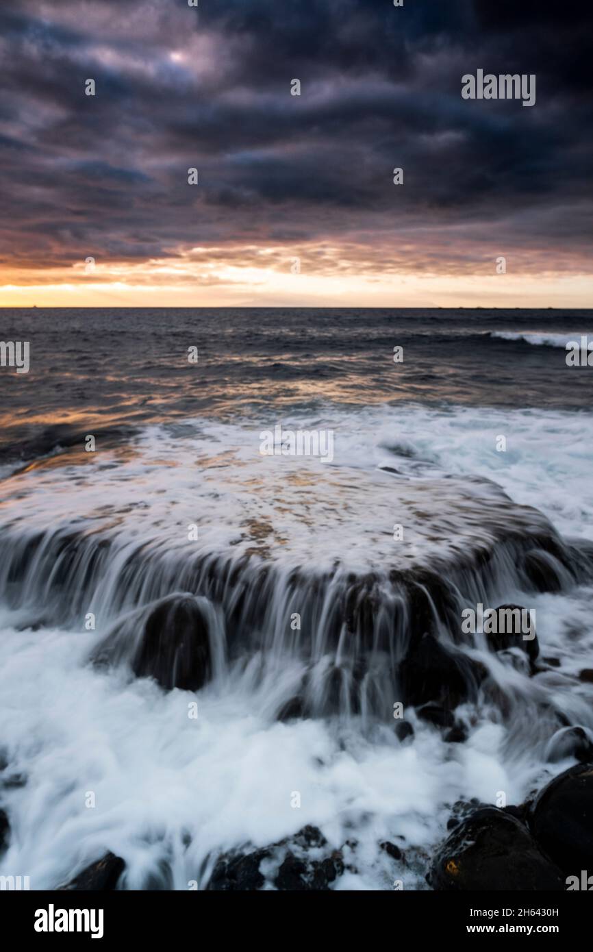 sunset landscape at the beach with sea ocean and waves in background ...