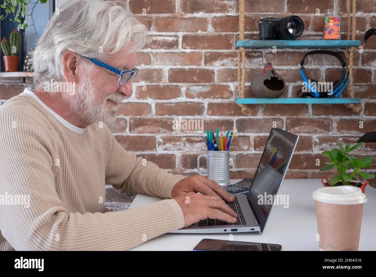 profile of elderly man browsing social media content using laptop on ...