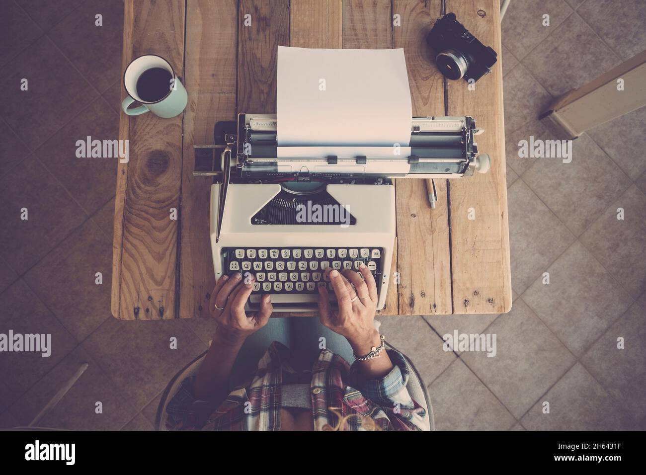 top view of woman hands typing on typewriter keypad on paper. woman ...
