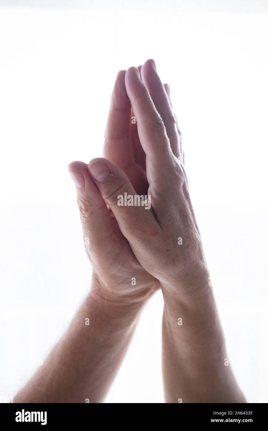 palm of human hands joined together in namaste prayer position over ...