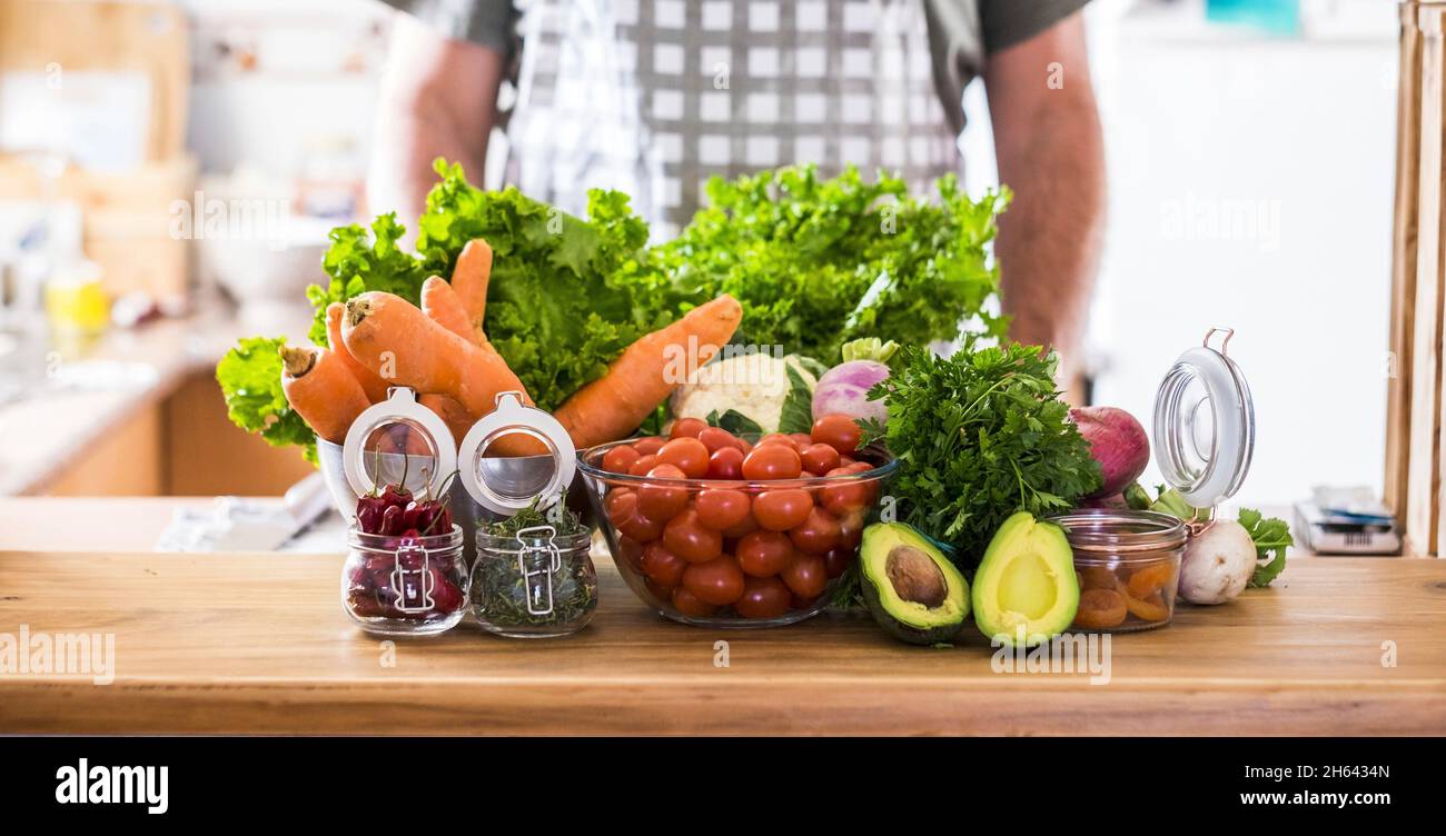 fresh vegetables with dried chillies and herbs on kitchen counter while ...