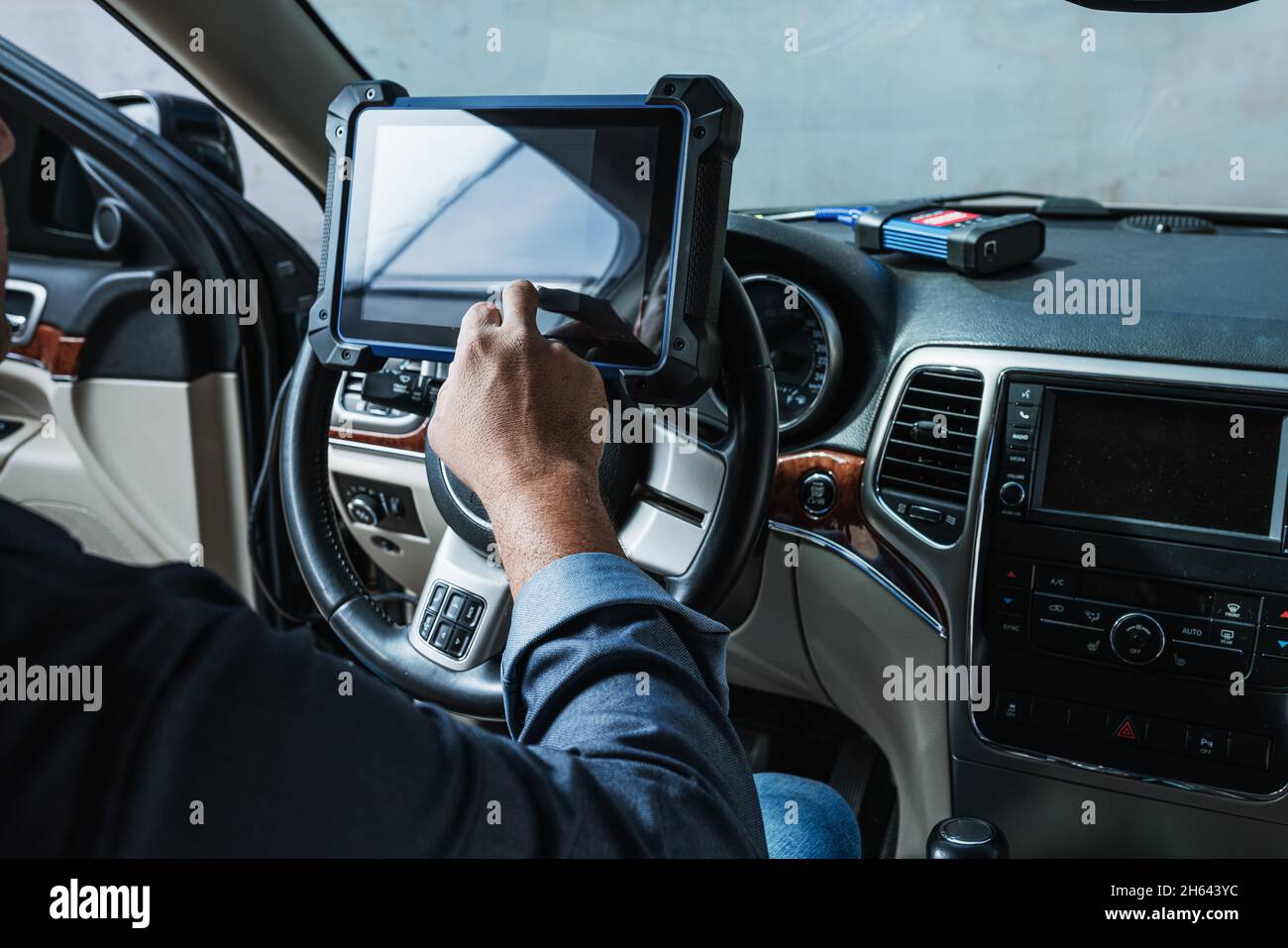 Car diagnostic. Technical inspection, car electronics. A Latin man ...