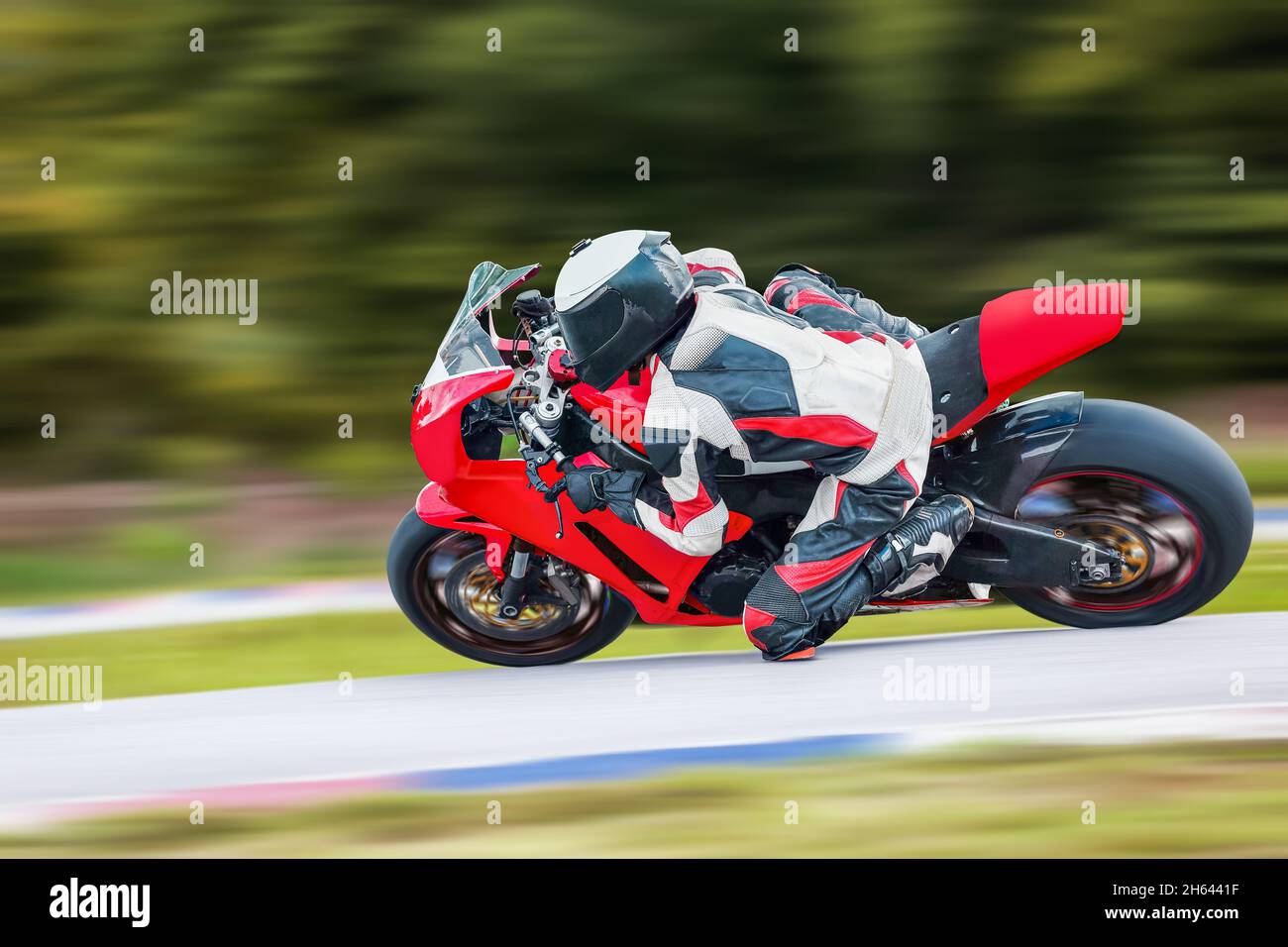 Motorcycle leaning into a fast corner on highway Stock Photo - Alamy