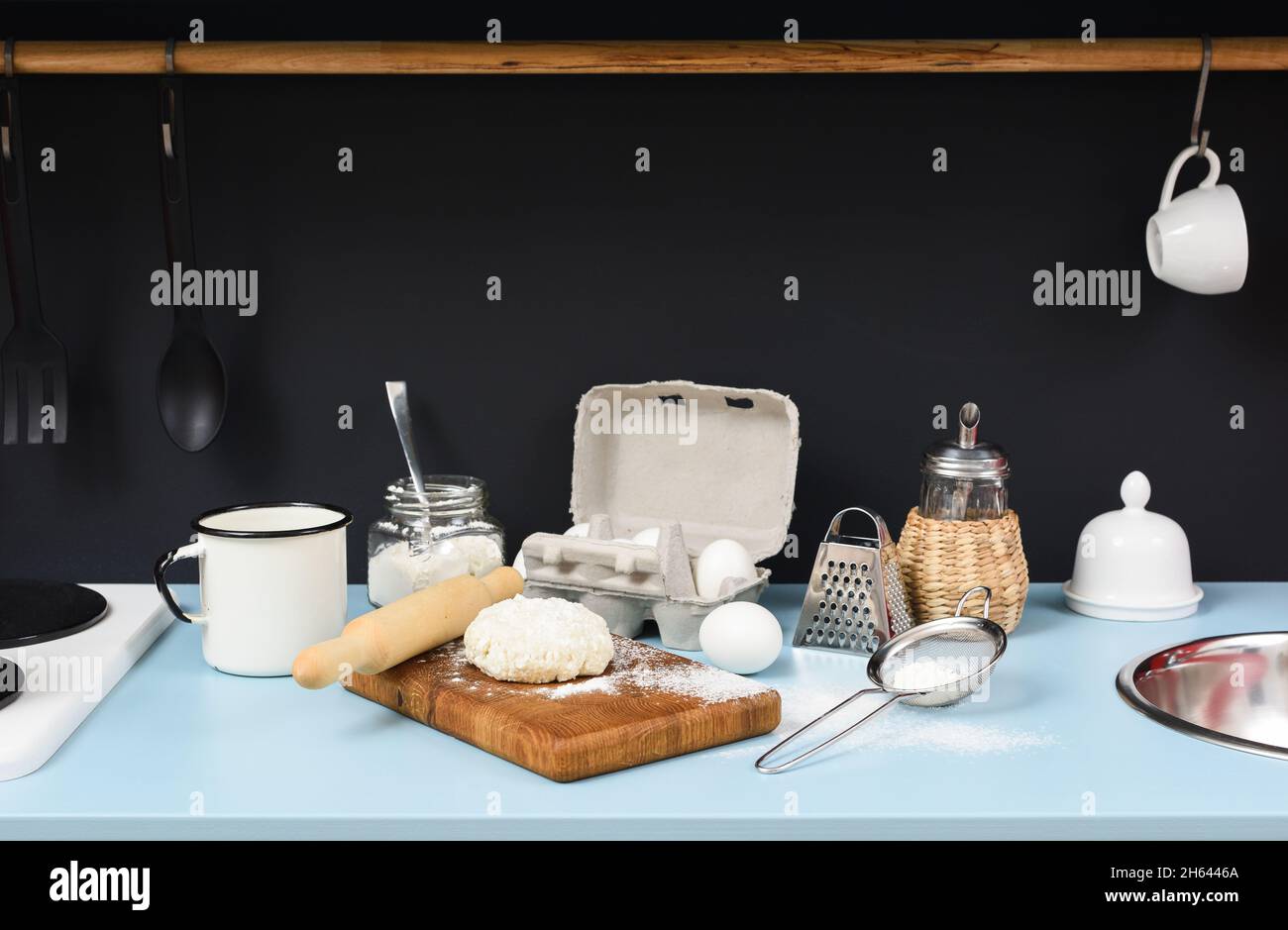 Kitchen table in process of making homemade cookies. Raw dough, rolling ...
