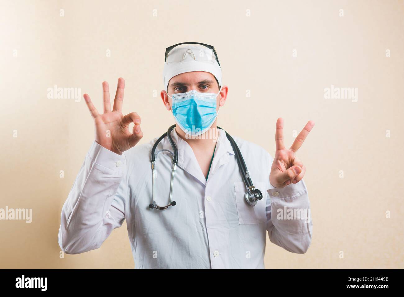 Present doctor in white suit and protective breathing mask glasses and ...