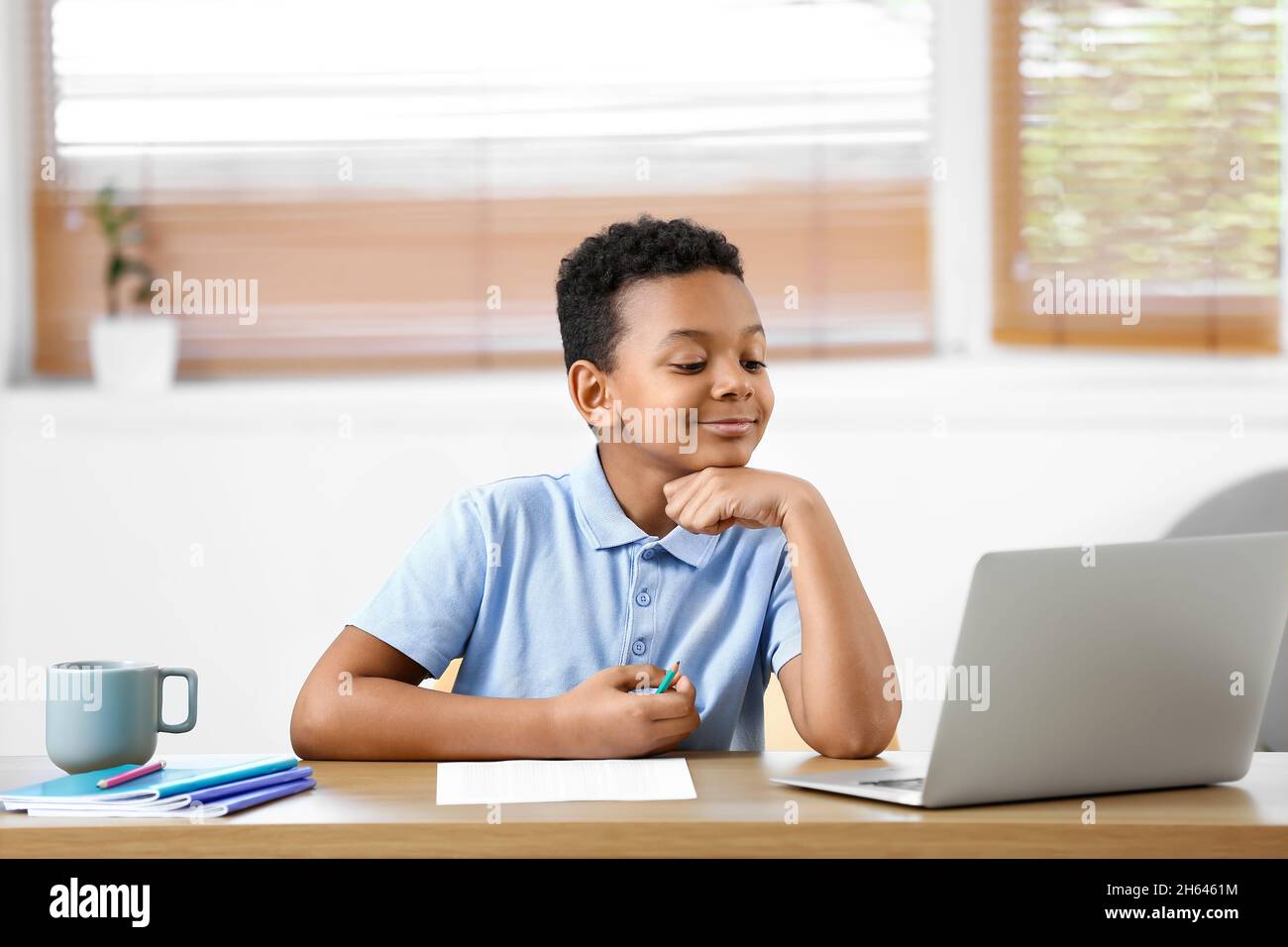 Little African-American boy studying online at home Stock Photo - Alamy