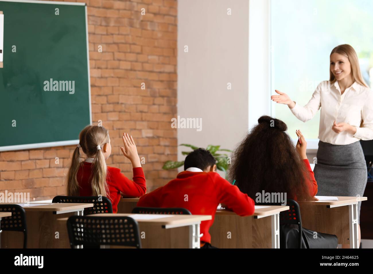 Teacher conducting lesson in classroom Stock Photo - Alamy
