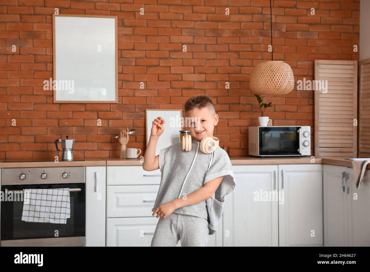 Cute little boy dancing in kitchen Stock Photo - Alamy