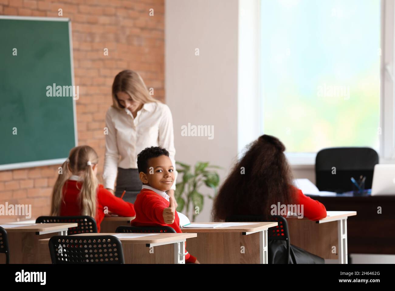 Teacher conducting lesson in classroom Stock Photo - Alamy