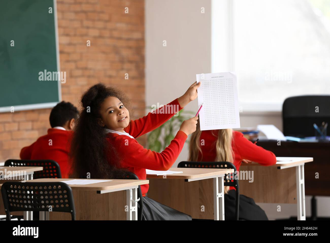Children sitting exam school uniform hi-res stock photography and ...
