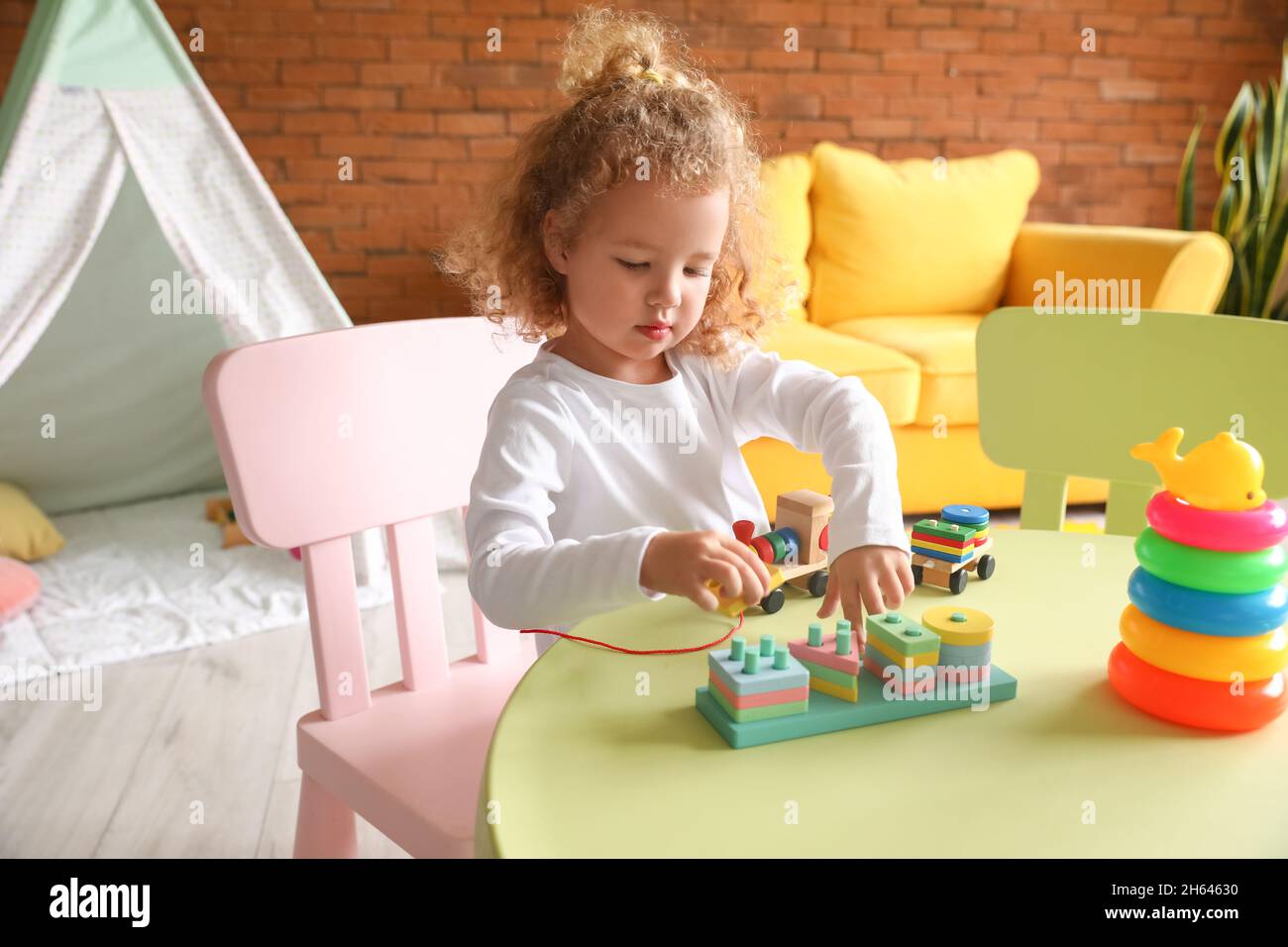 Cute baby girl playing at home Stock Photo - Alamy