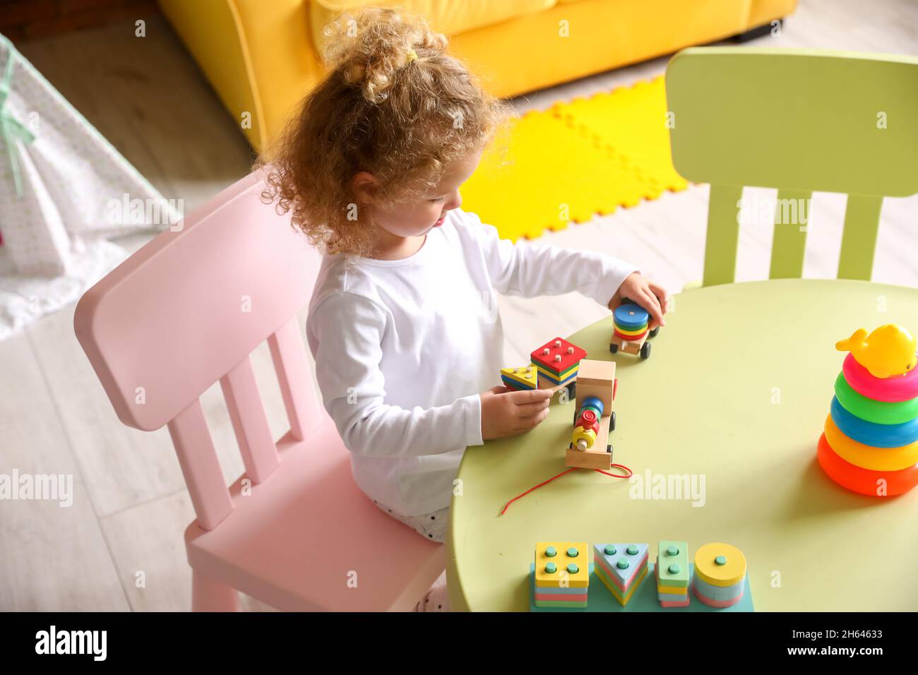 Cute baby girl playing at home Stock Photo - Alamy