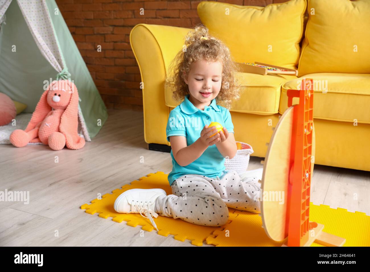 Cute baby girl playing at home Stock Photo - Alamy