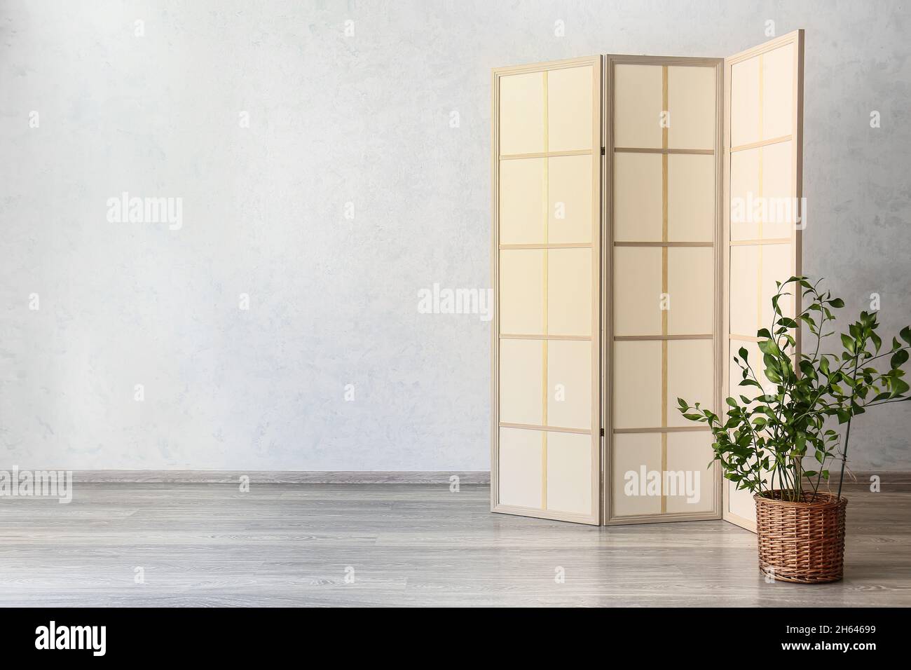 Stylish folding screen near wall in room interior Stock Photo - Alamy
