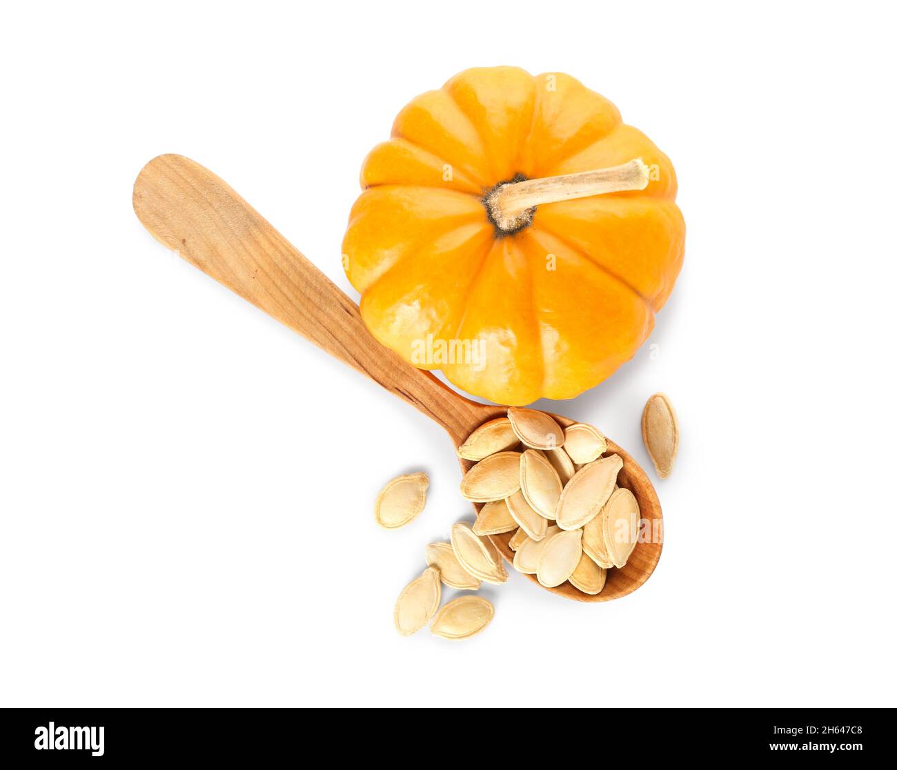 Spoon with pumpkin seeds on white background Stock Photo - Alamy