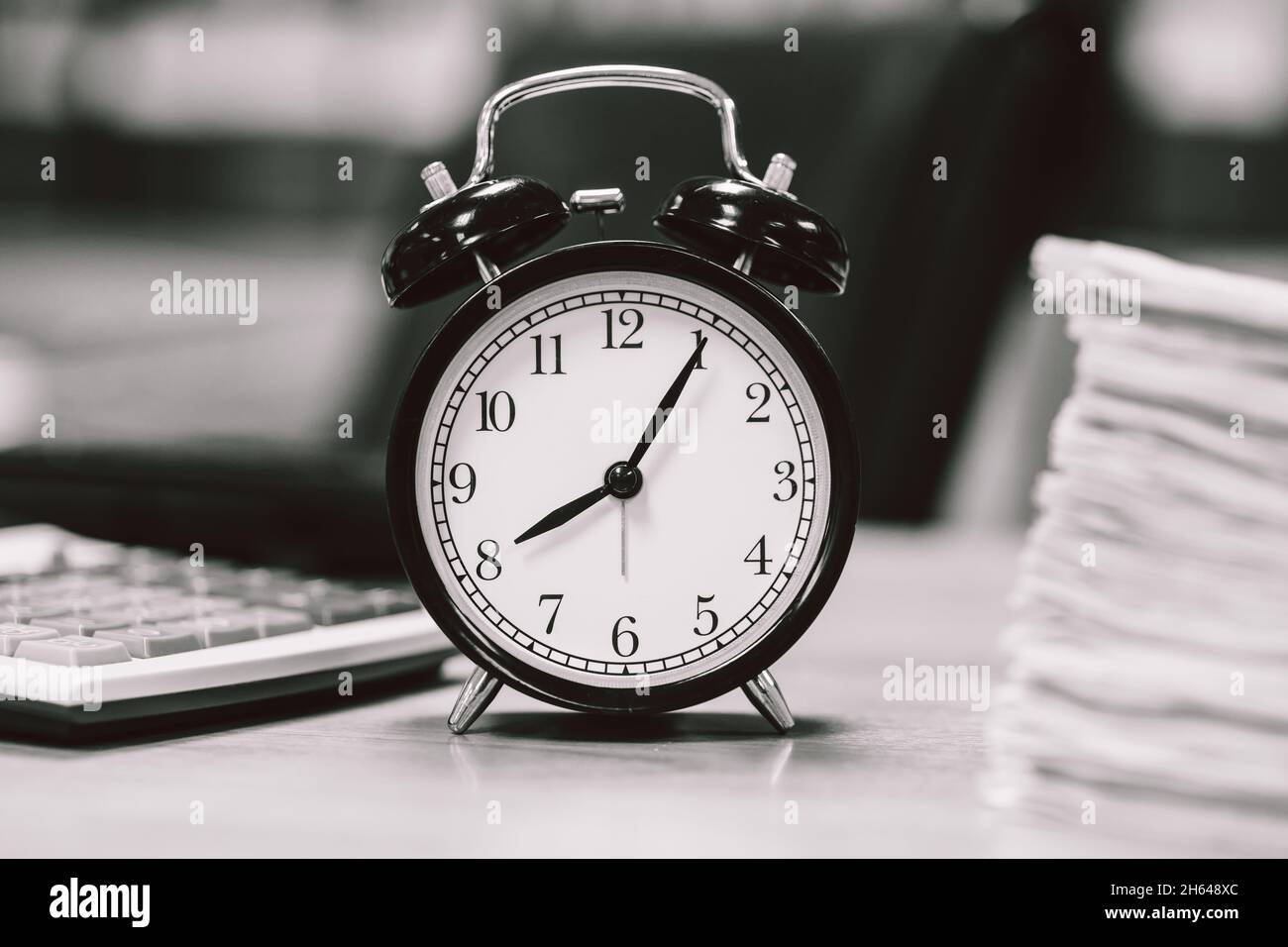 alarm time clock on office working table for working hours black and ...