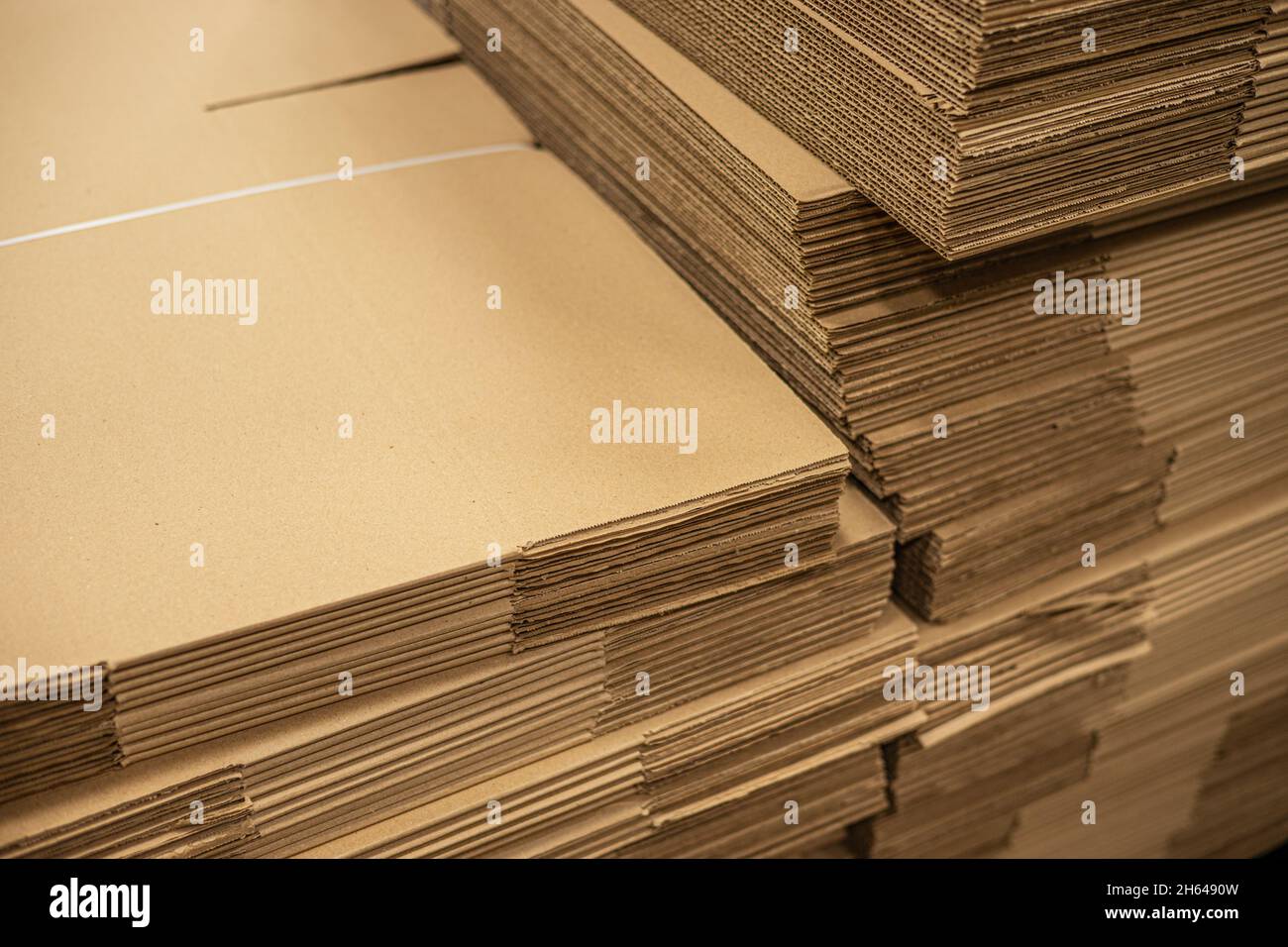 Corrugated fiberboard brown box paper cardboard folded pile stack in ... Corrugated fiberboard brown box paper cardboard folded pile stack in ...