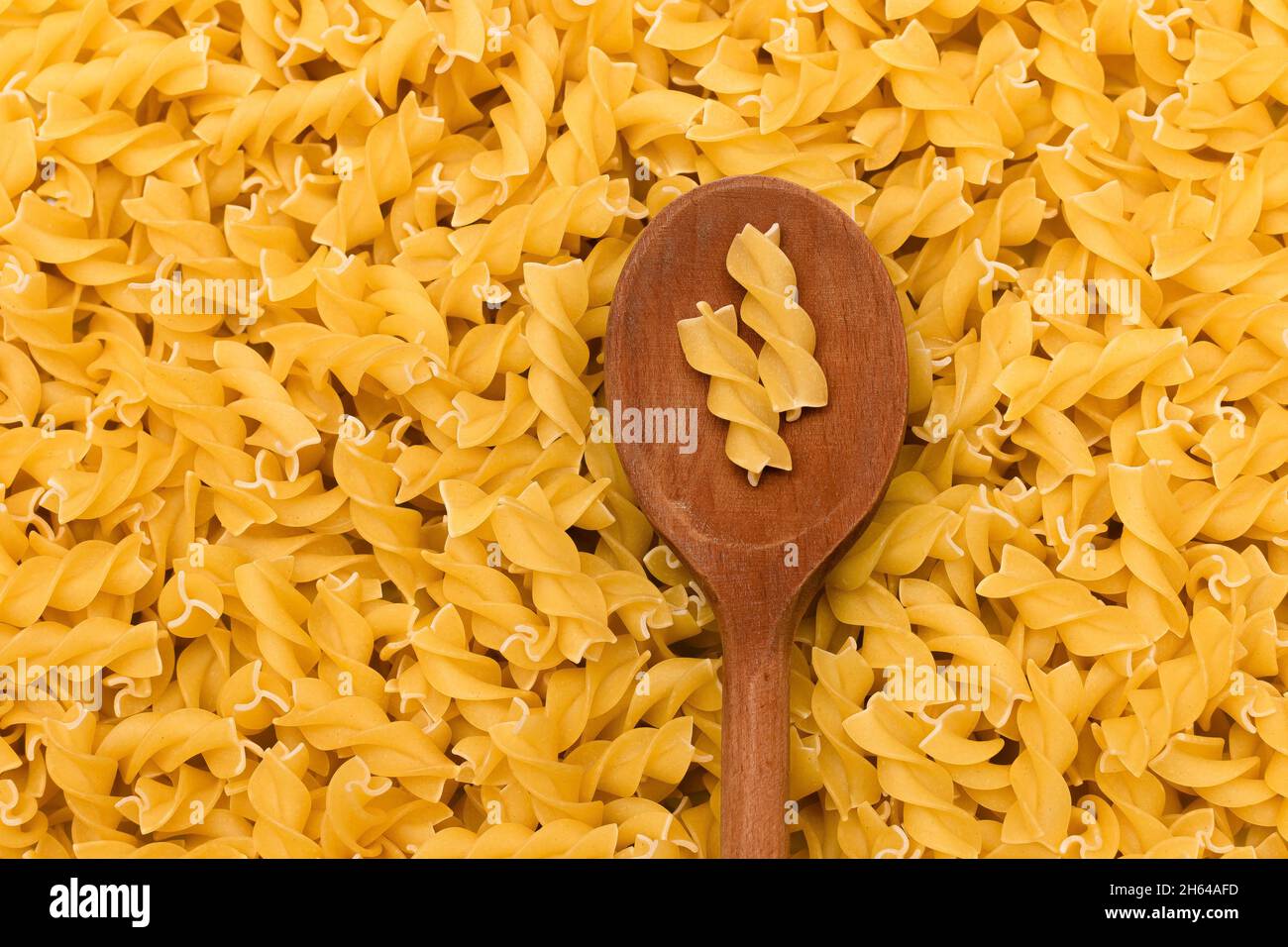 Uncooked Fusilli Pasta with Wooden Spoon. Raw and Dry Macaroni ...