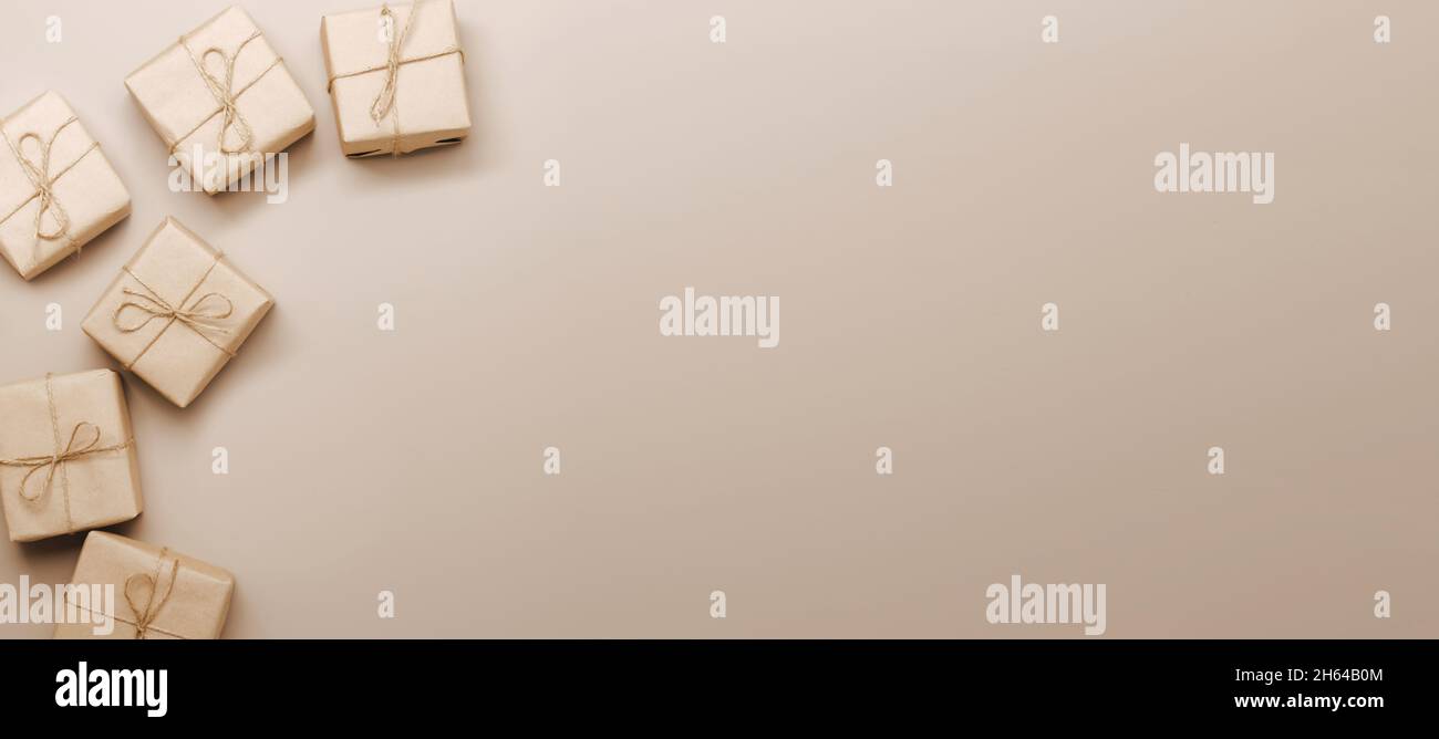 Gifts in eco-friendly paper packaging on a trendy beige background ...