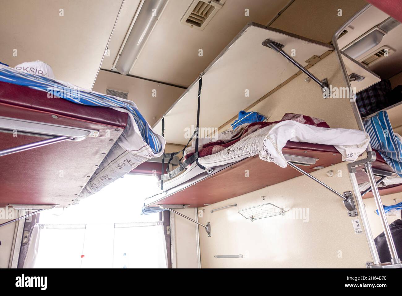 Empty berthes with unmade bed in the 3 class car, platzcart carriage in ...