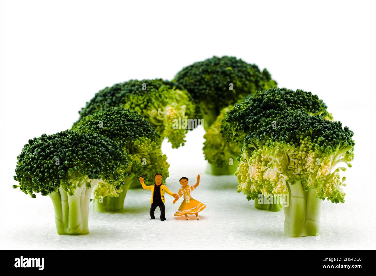 Miniature figurines dancing through a "forest" of broccoli trees Stock ...