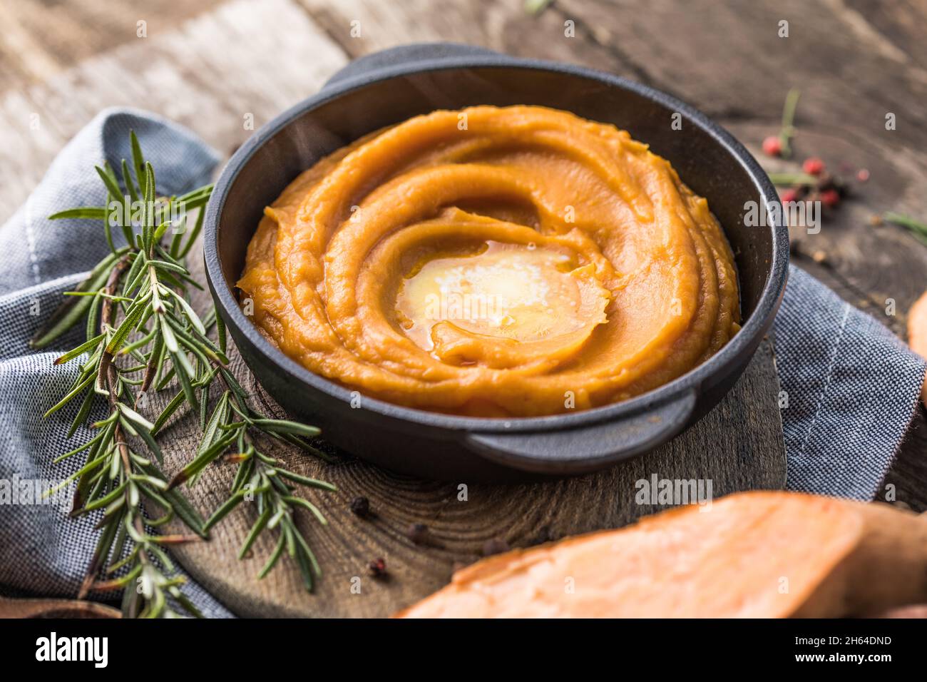 Spicy mashed sweet potato or sweet potato puree with rosemary in a ...