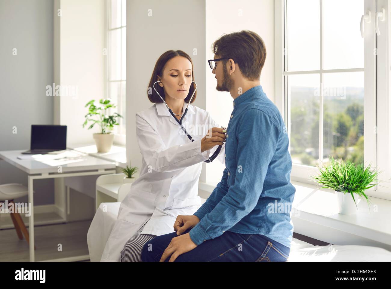 Young male patient gets his breath or heartbeat checked during his ...