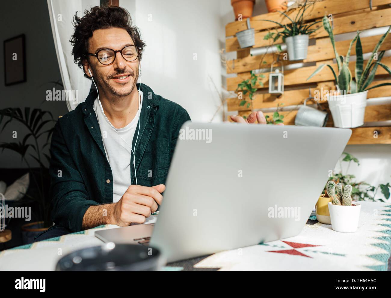 Man with laptop working remotely from home. Freelancer at remote work ...