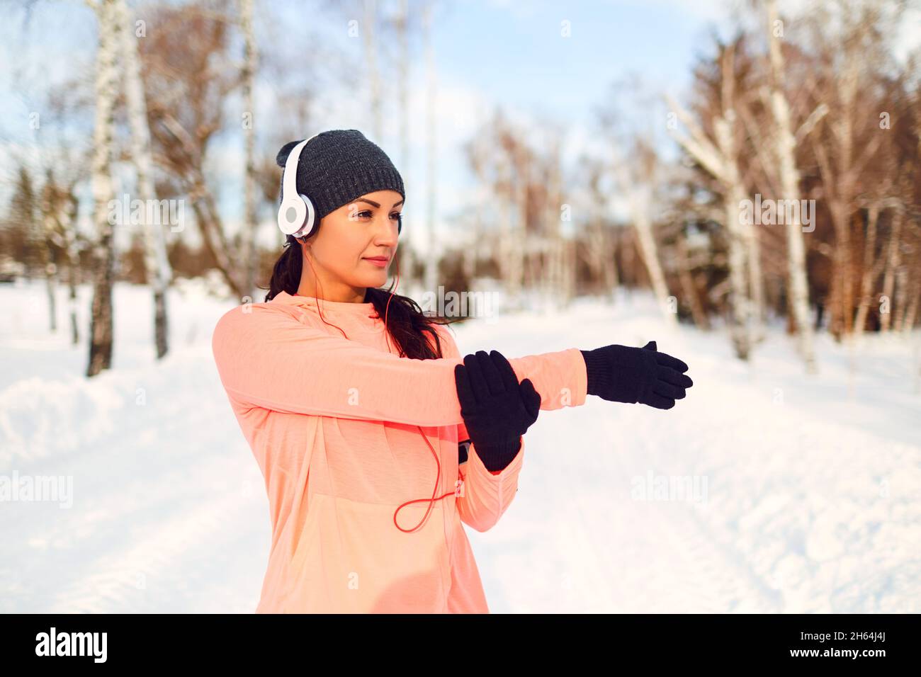 Girl athlete does stretching in the snow in the winter Stock Photo - Alamy