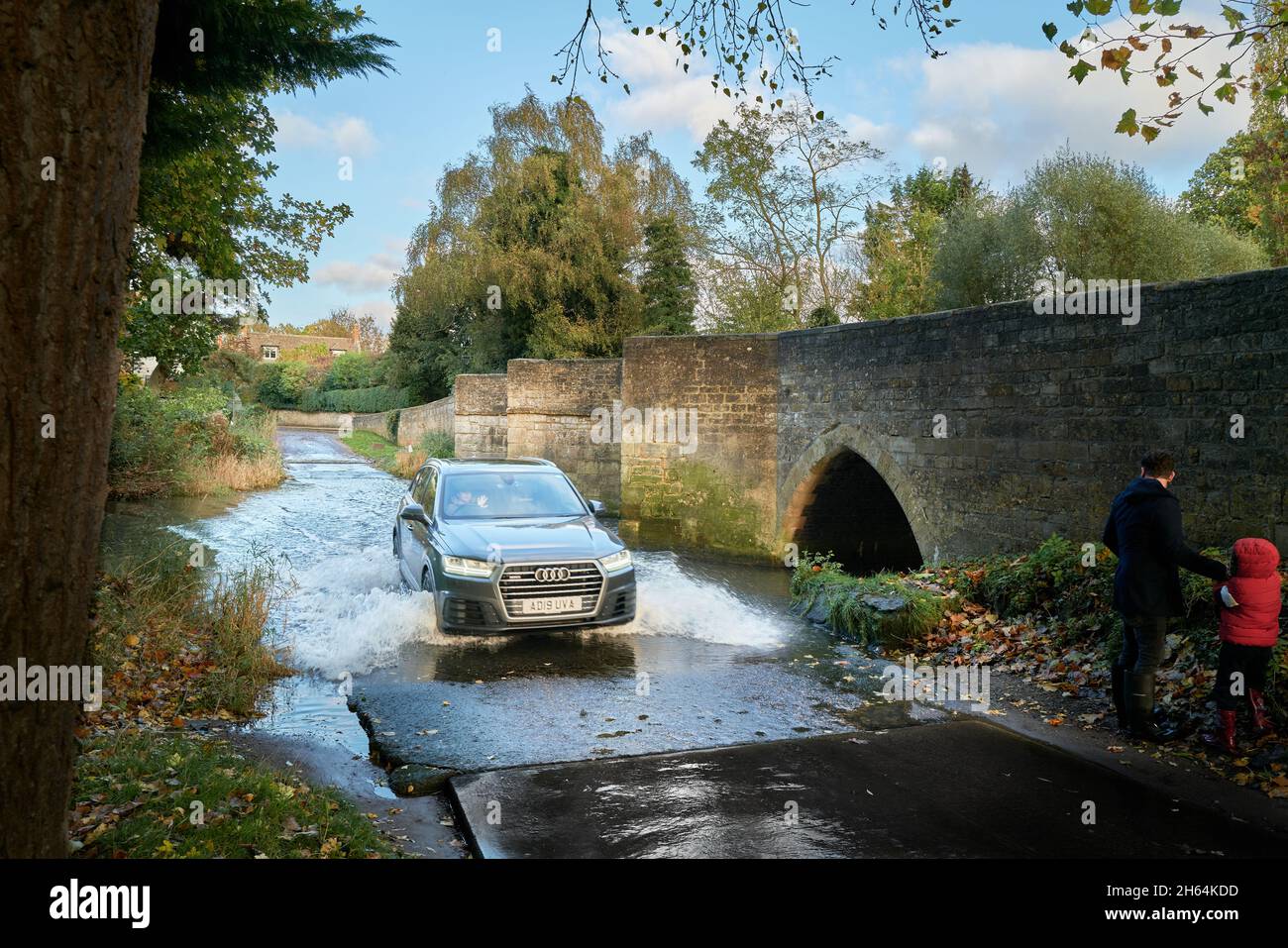 A car drives through the ford beside the 13th century bridge over the ...