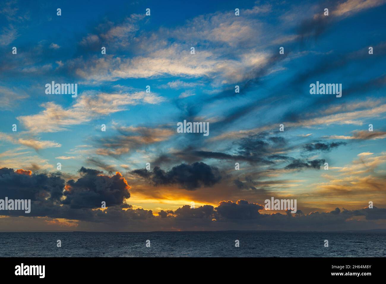 The setting sun lighting up the cloud cover Stock Photo - Alamy