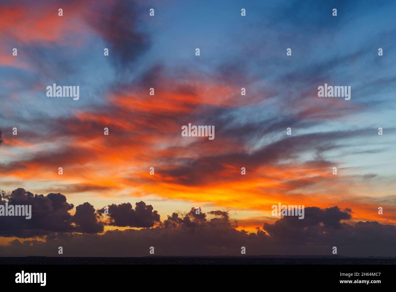 The setting sun lighting up the cloud cover Stock Photo - Alamy