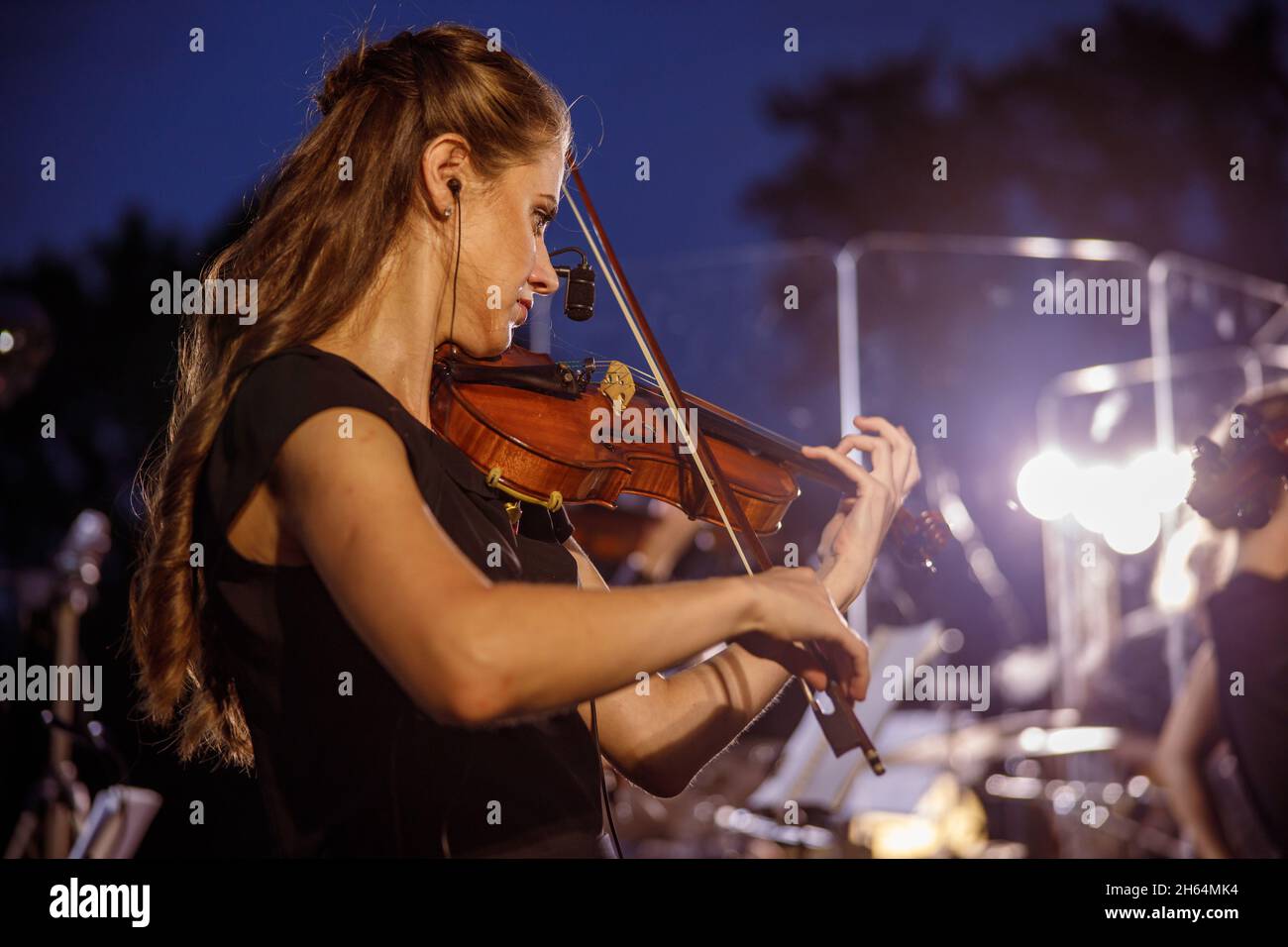 Beautiful woman playing violin at night outdoor concert Stock Photo - Alamy